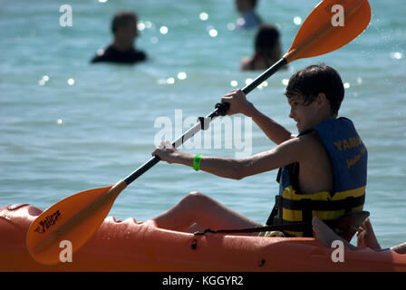 Boy riding a kayak at a resort in Riviera Maya, Mexico Stock Photo - Alamy