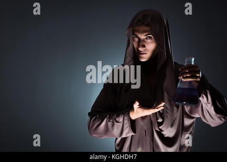 Alchemist doing experiments in alchemy concept Stock Photo - Alamy