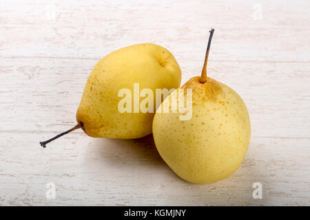 Sweet Chinese pear over the wooden background Stock Photo - Alamy