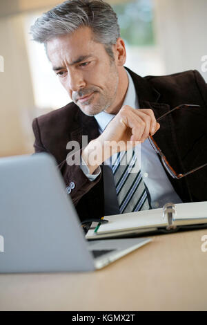 Attorney working in office on laptop Stock Photo - Alamy
