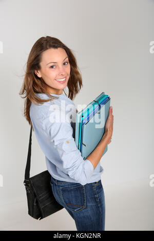 Cheerful student girl holding files Stock Photo - Alamy