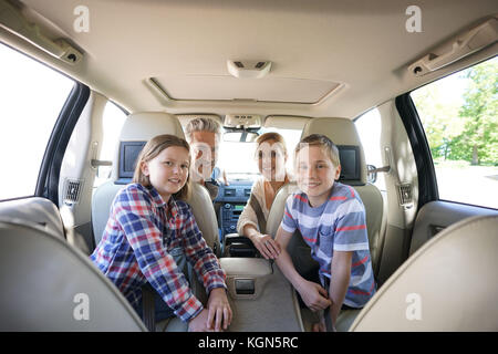 Happy family inside car leaving for vacation Stock Photo - Alamy