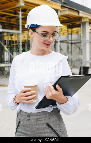 Beautiful young woman holding paper heart and flowers on red background ...
