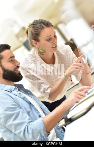 Colleagues in office checking agenda Stock Photo - Alamy