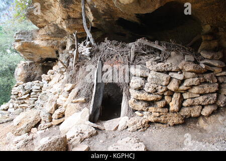 Stone and wood shelters made in cavemen style Stock Photo - Alamy