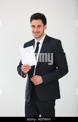 Smiling businessman holding blank flyer Stock Photo - Alamy