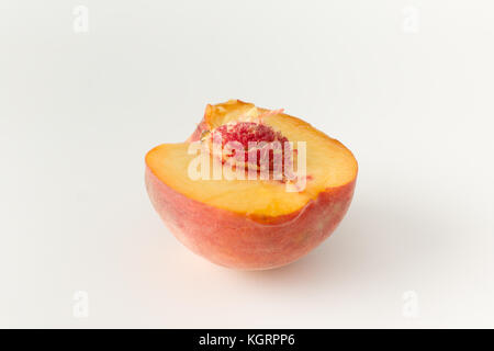 Fresh dissected peach with stone on white background Stock Photo - Alamy