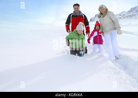 Family walking in deep snow track Stock Photo - Alamy