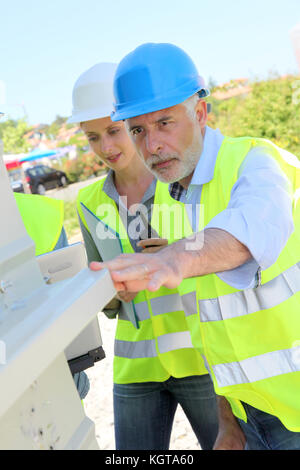 Construction workers checking building structure Stock Photo - Alamy