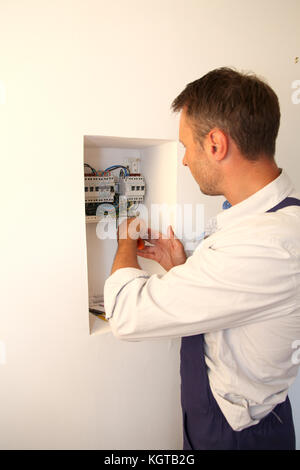 Electrician installing electricity meter indoors, closeup view Stock ...