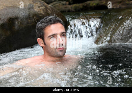 Closeup of man bathing in natural river water Stock Photo - Alamy