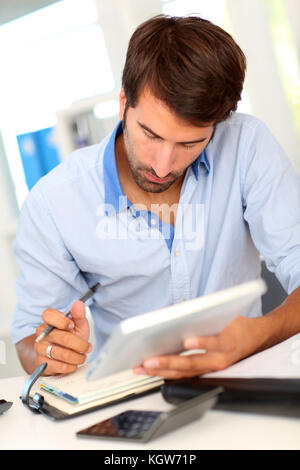 Portrait of office worker using electronic tablet Stock Photo - Alamy