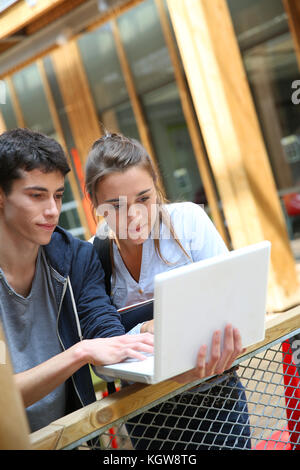 Teenagers working on laptop in school campus Stock Photo - Alamy