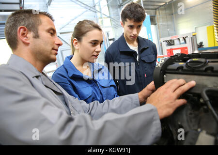 Students with instructor working on auto engine Stock Photo - Alamy