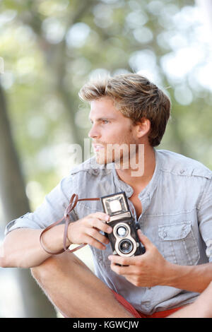 Trendy photographer using vintage camera Stock Photo - Alamy