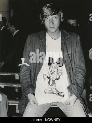 Student in hippie attire, including a t-shirt with a caricature of ...