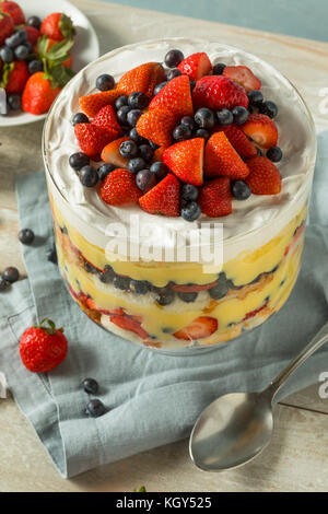 Sweet strawberry trifle dessert in glass with pudding and cookies on ...