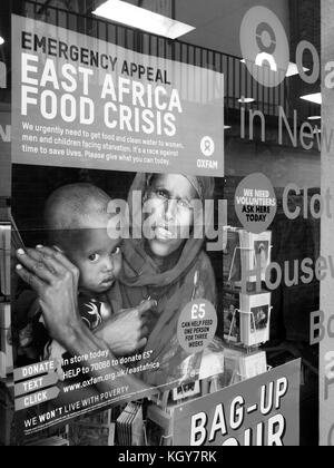 Oxfam emergency appeal poster in charity shop window, East Africa food ...