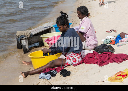 Two African women washing clothes by hand in buckets. Accra, Ghana ...