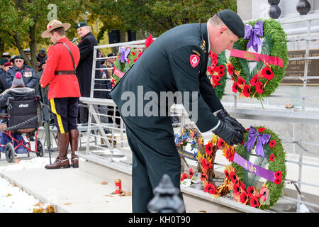 Canadian poppy for remembrance day with Canada flag pin on dark ...