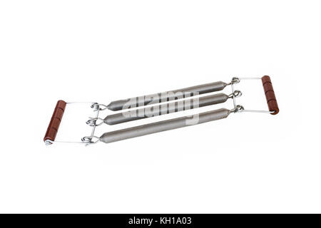 Traditional spring chest expanders against a white background Stock ...