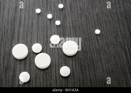 Some Round White Pills Of Different Size Stock Photo - Alamy