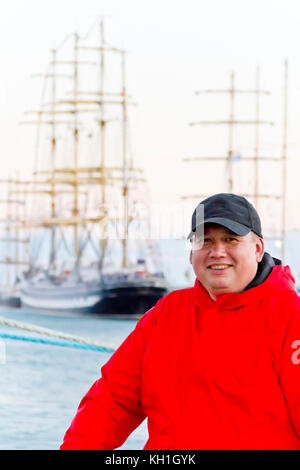 cheerful overweight man in red sunglasses and superhero cloak using ...