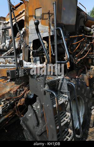 Closeup of combine harvester destroyed by fire Stock Photo - Alamy