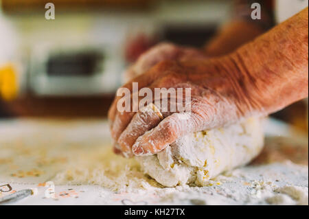 old italian grandma making pasta in the kitchen sepia effect Stock ...