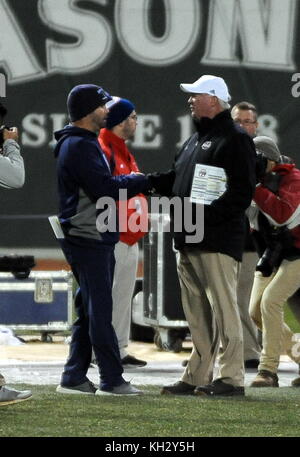 Massachusetts head coach Mark Whipple, left, and Akron head coach Terry ...