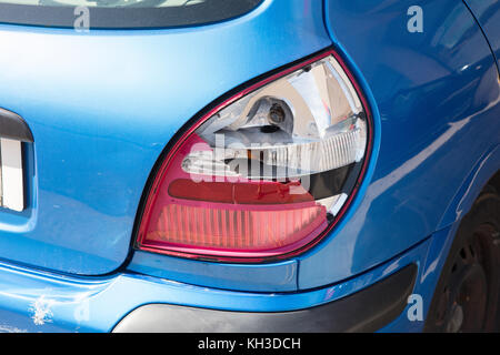 Broken taillight of a blue car close up Stock Photo - Alamy
