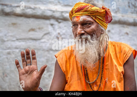 Sadhu baba pose raising the blessing hand at the Ganga river bank in ...
