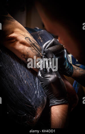 Process of making tattoo close-up Stock Photo - Alamy
