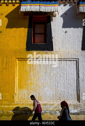 Two Tibetan women pilgrims in traditional dress, including their ...
