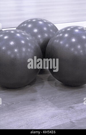 Medium size black balls for pilates exercises Stock Photo - Alamy