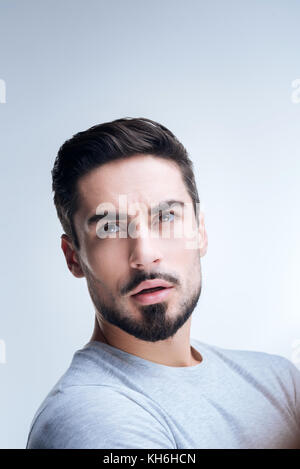 Close-up of surprised handsome man looking impressed left, open mouth ...