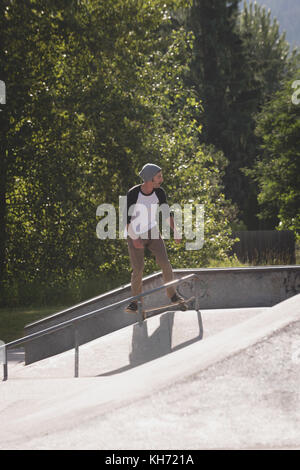 Skateboarder performing a stunt Stock Photo - Alamy