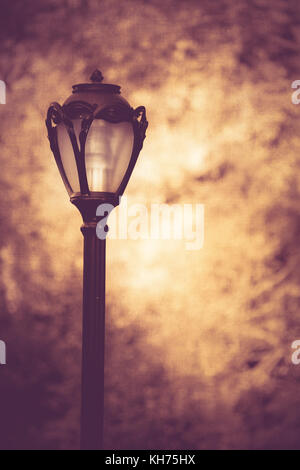 Street antique style lamp post with effect of shine from low light of ...
