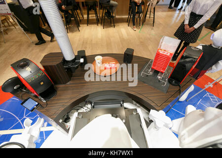 Robot duAro serves a cup of coffee during a media event at the Nescafe ...