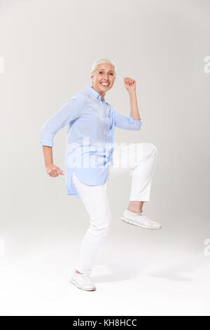 Photo of funny elder white hair lady talk telephone wear teal blouse ...