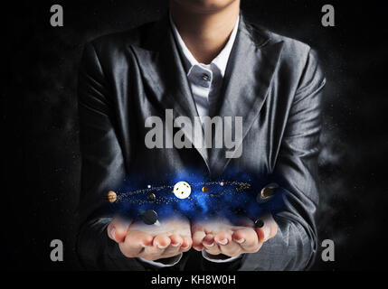 Businessman presenting solar system Stock Photo - Alamy