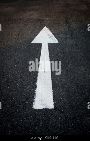 Closeup of a white direction arrow painted on an asphalt road Stock ...