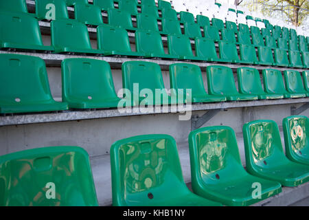 green plastic stadium chairs for fans Stock Photo - Alamy