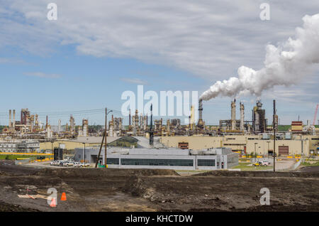 The largest Canadian oil refinery in the background, oil sand in the ...