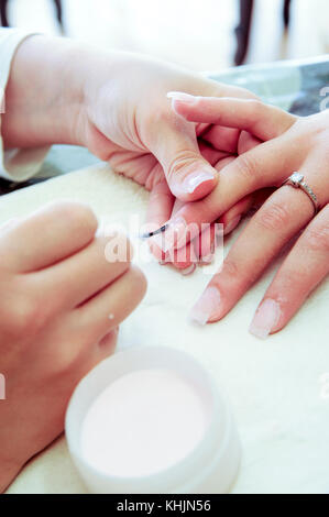 Woman hands receiving a manicure in beauty salon, outdoors beauty ...