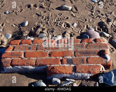 eroded bricks lying on beach Stock Photo - Alamy