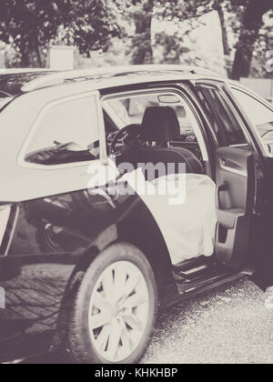 Bride getting out of limo Stock Photo - Alamy