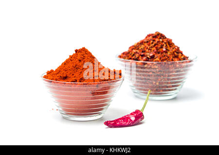Smashed red pepper powder in a glass bowl isolated Stock Photo - Alamy