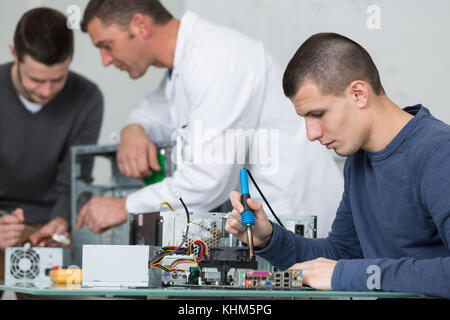 Repairman soldering electronic components on cpu Stock Photo - Alamy
