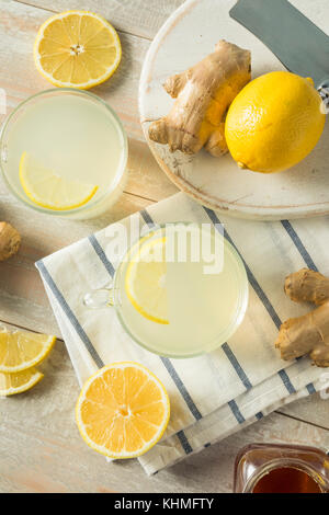Healthy ginger tea with lemon and honey on table on light background ...